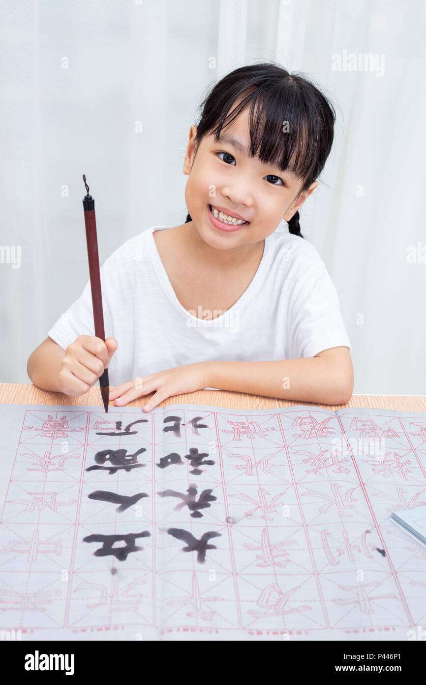 Asian little Chinese girl practice Chinese calligraphy at home Stock ...