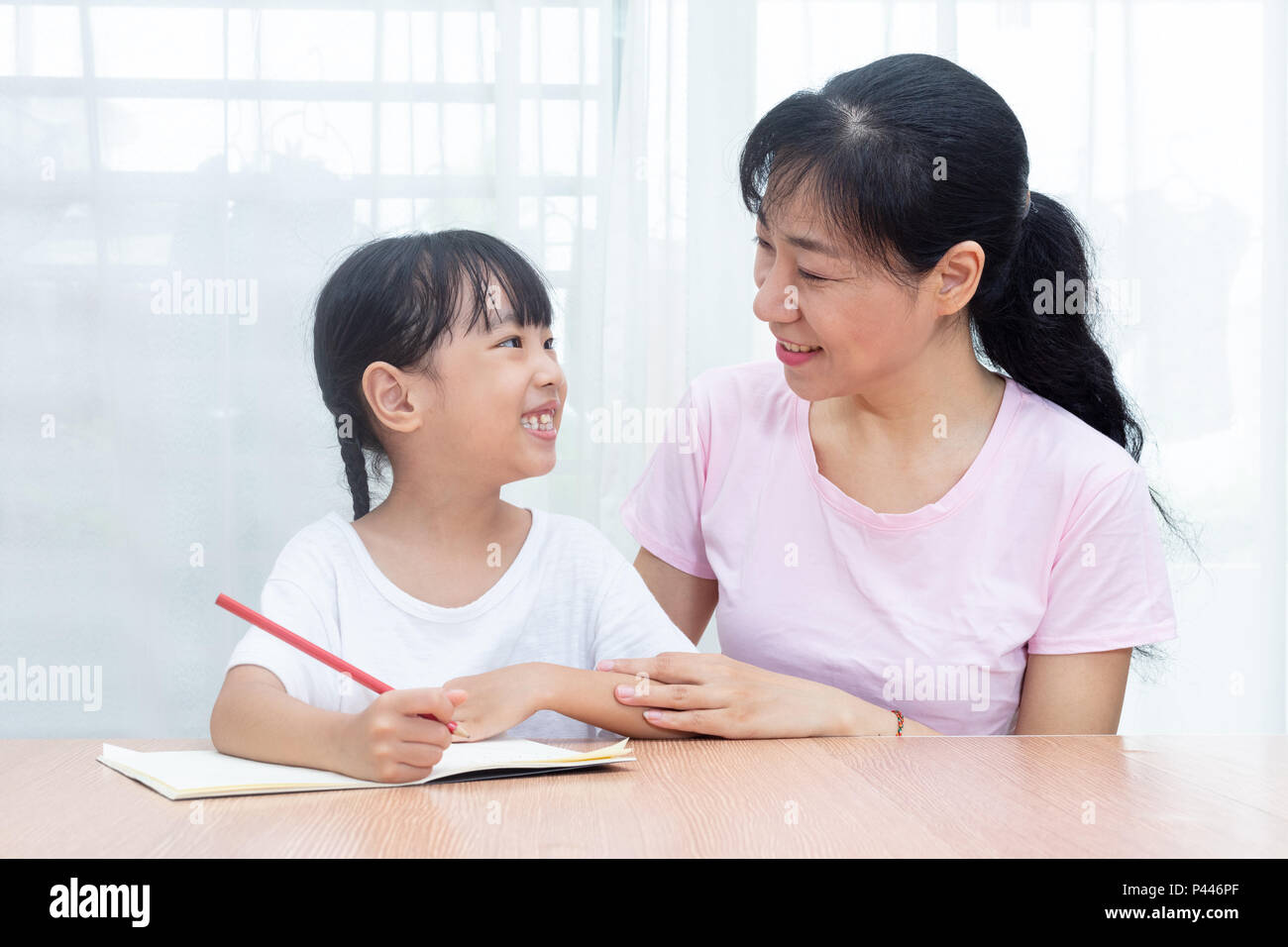 Asian Chinese mother teaching daughter doing homework at home Stock ...