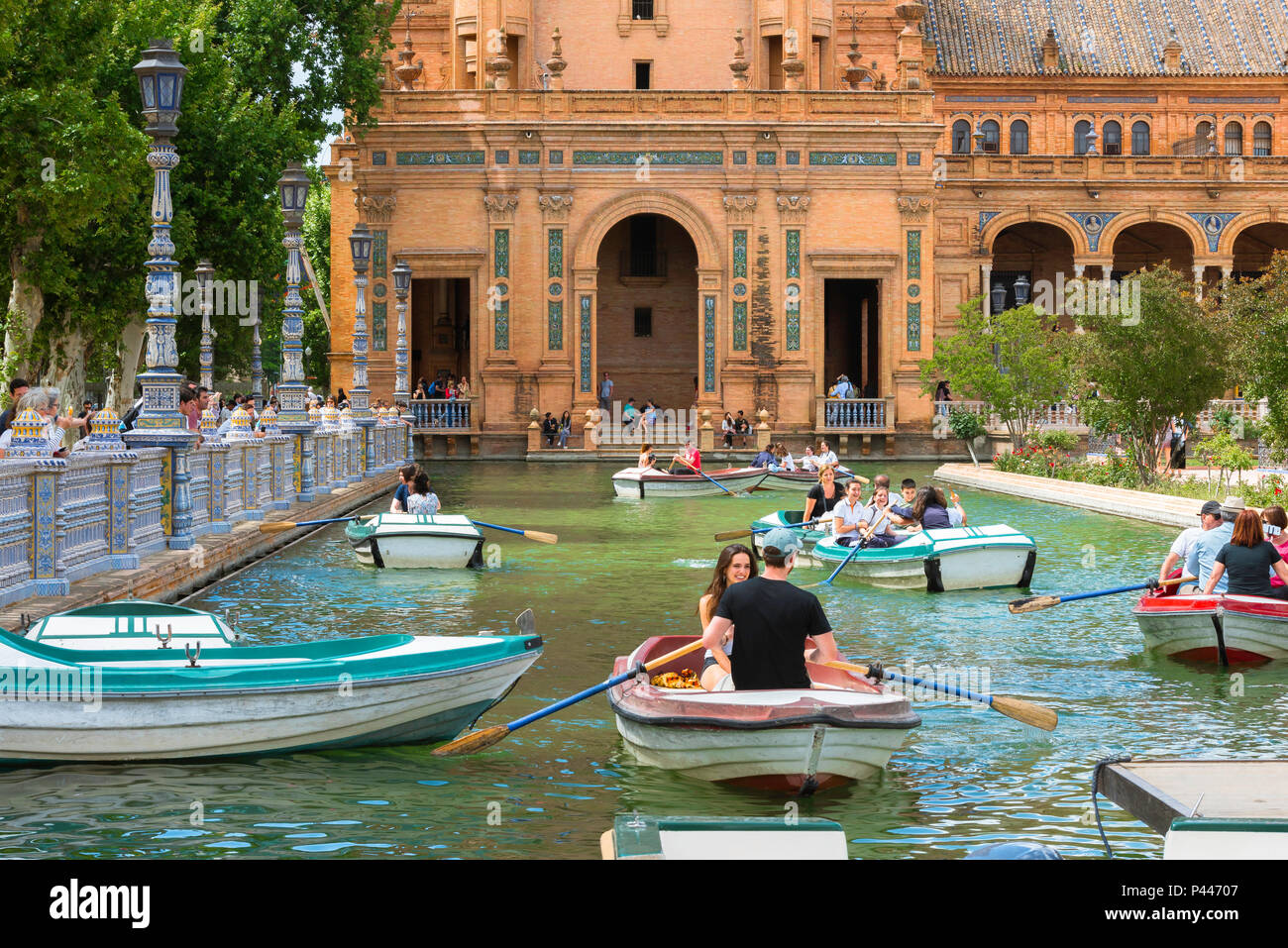 Plaza de Espana Seville, view of tourists rowing boats on the boating ...