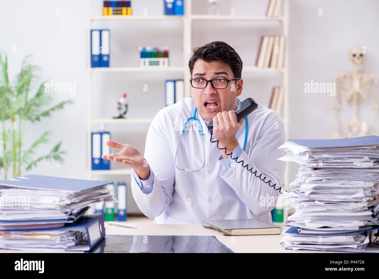 Busy doctor with too much work in hospital Stock Photo - Alamy