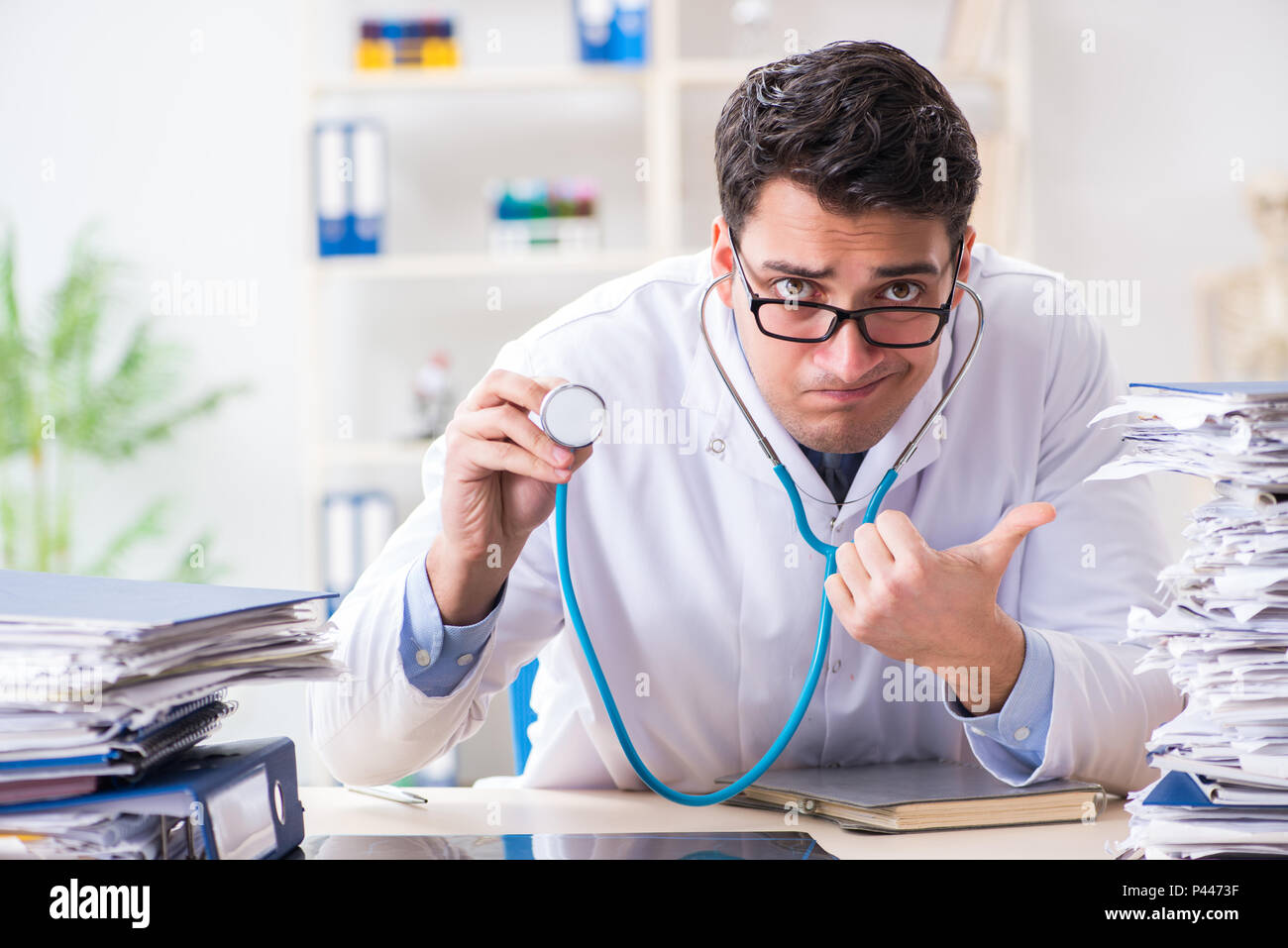 Busy doctor with too much work in hospital Stock Photo - Alamy