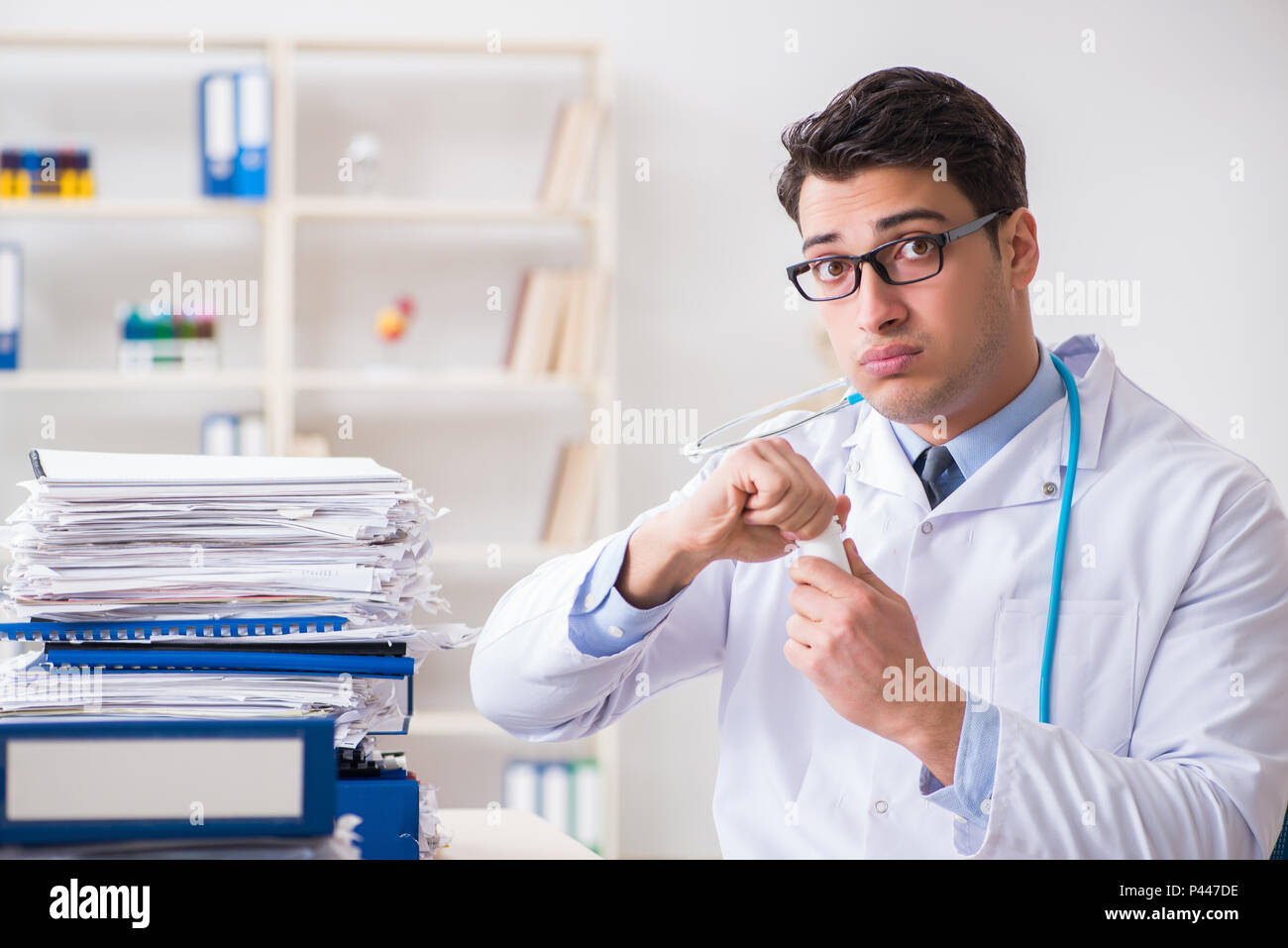 Busy doctor with too much work in hospital Stock Photo - Alamy