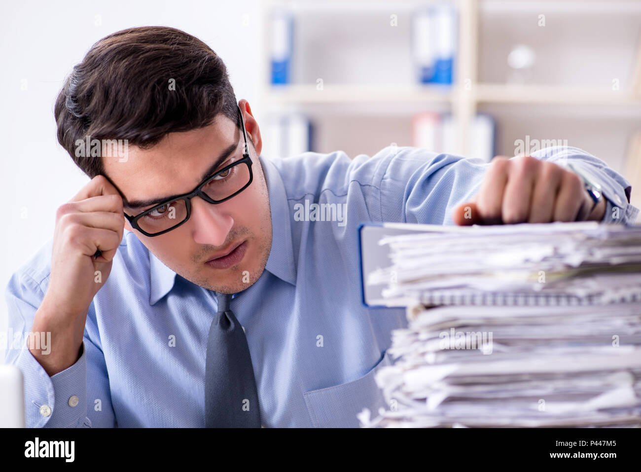 Extremely busy businessman working in office Stock Photo - Alamy