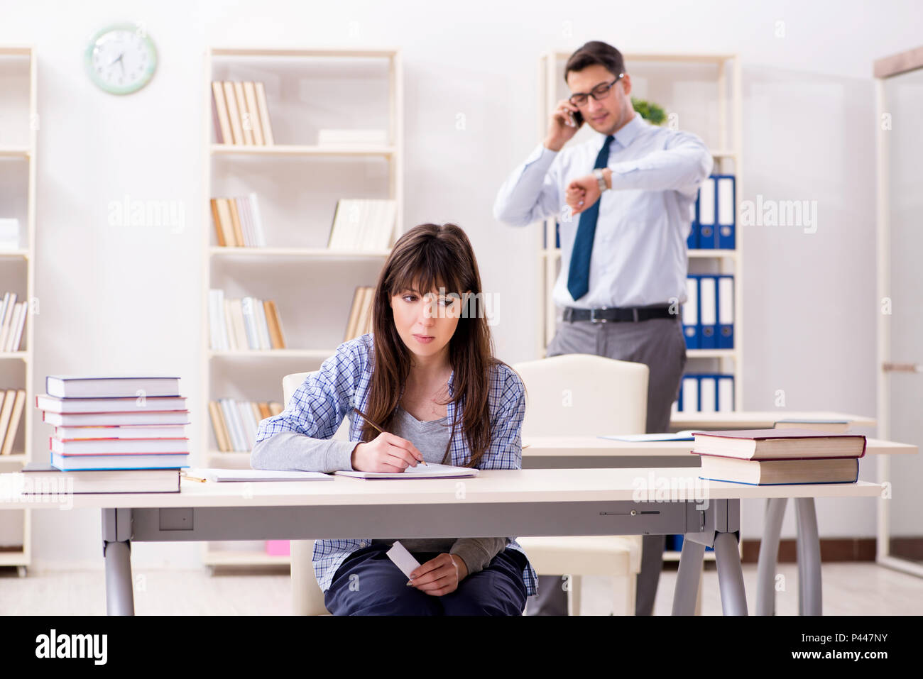 Male lecturer giving lecture to female student Stock Photo - Alamy