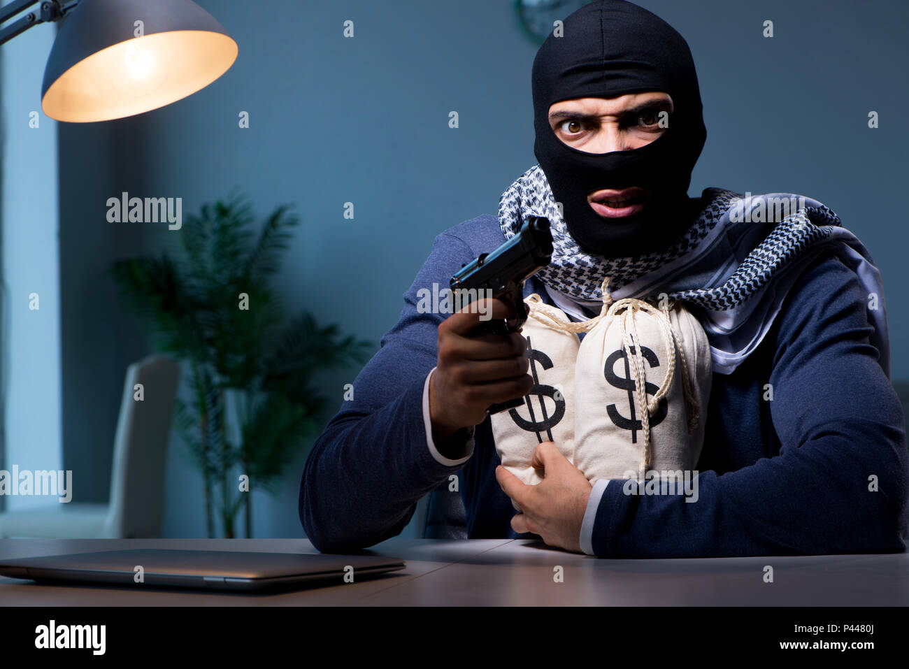 Terrorist burglar with gun asking for money ransom Stock Photo - Alamy
