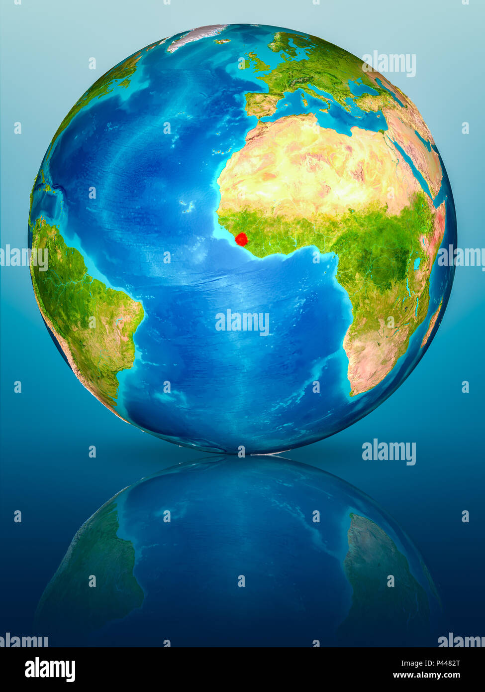 Sierra Leone in red on model of planet Earth on reflective blue surface ...