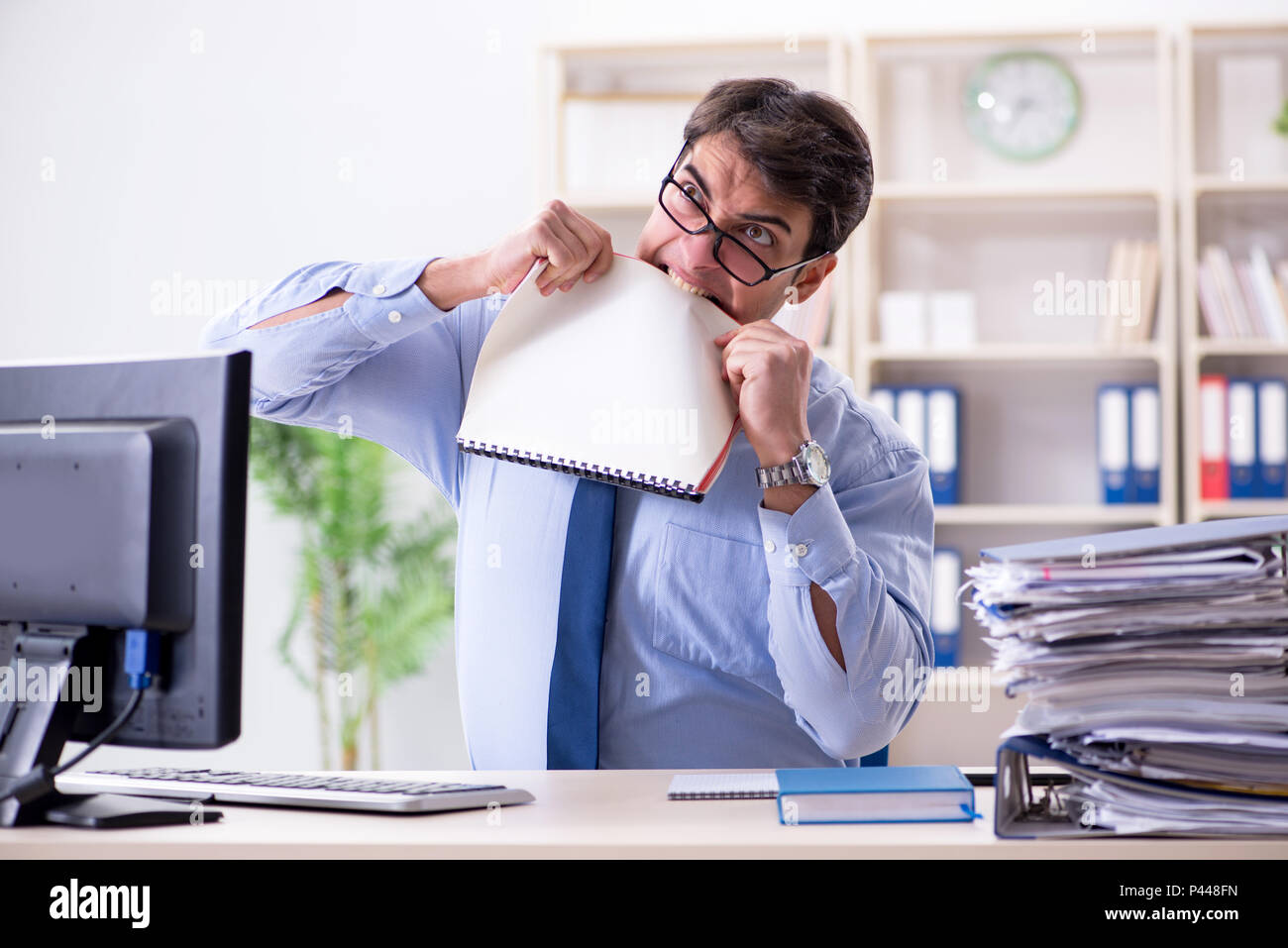 Tired businessman with too much paperwork Stock Photo - Alamy