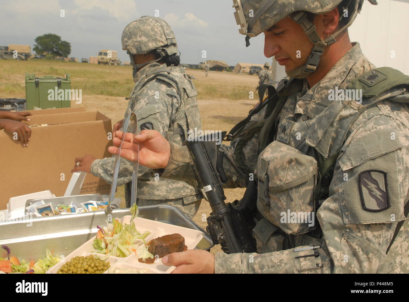 Sgt. Alex Garvey, Company C, 106th Support Battlion, adds salad to his ...