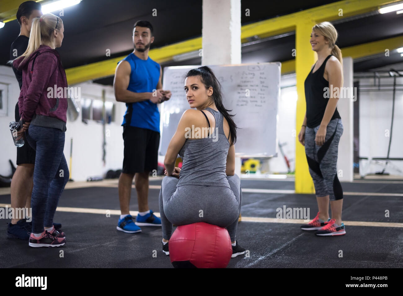 Training course.group of young athletes getting instructions from ...