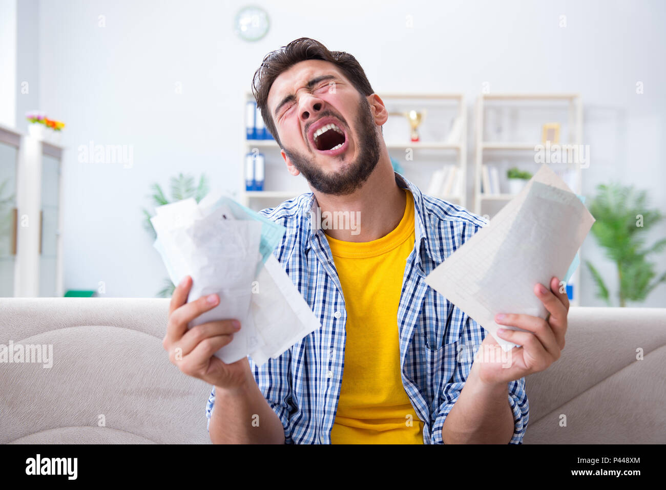 Man angry at bills he needs to pay Stock Photo - Alamy