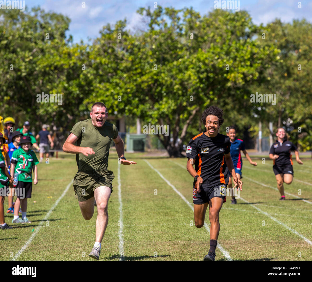 Lance Cpl. Ethan N. Fuller races a student during a sports day event at ...