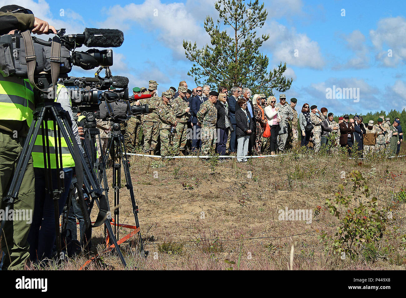 Members of the local media and distinguished visitors gather before a ...