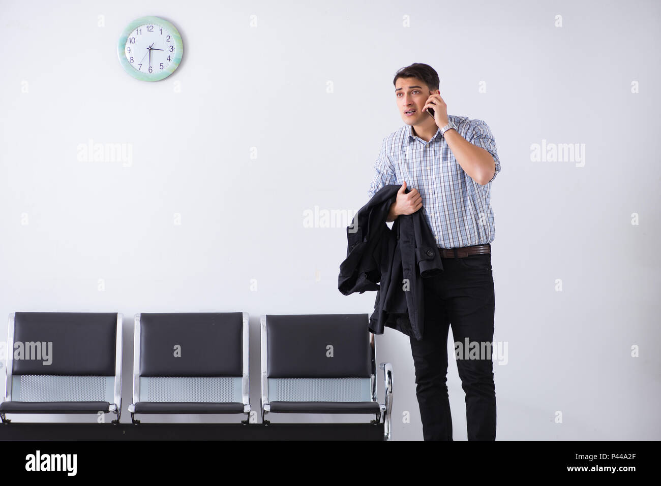 Frustrated businessman waiting in airport hi-res stock photography and ...
