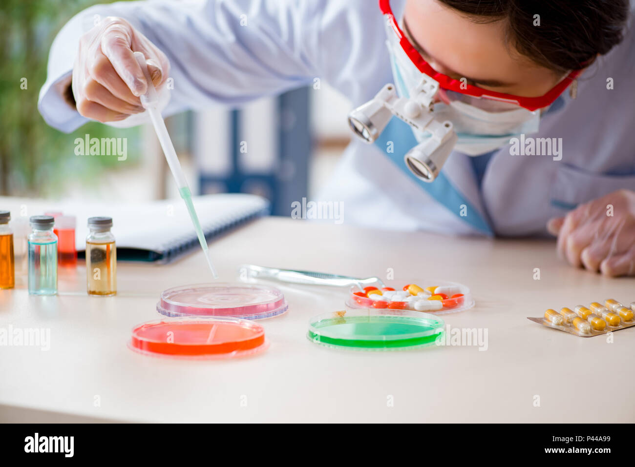 Lab assistant in drug synthesis concept Stock Photo - Alamy