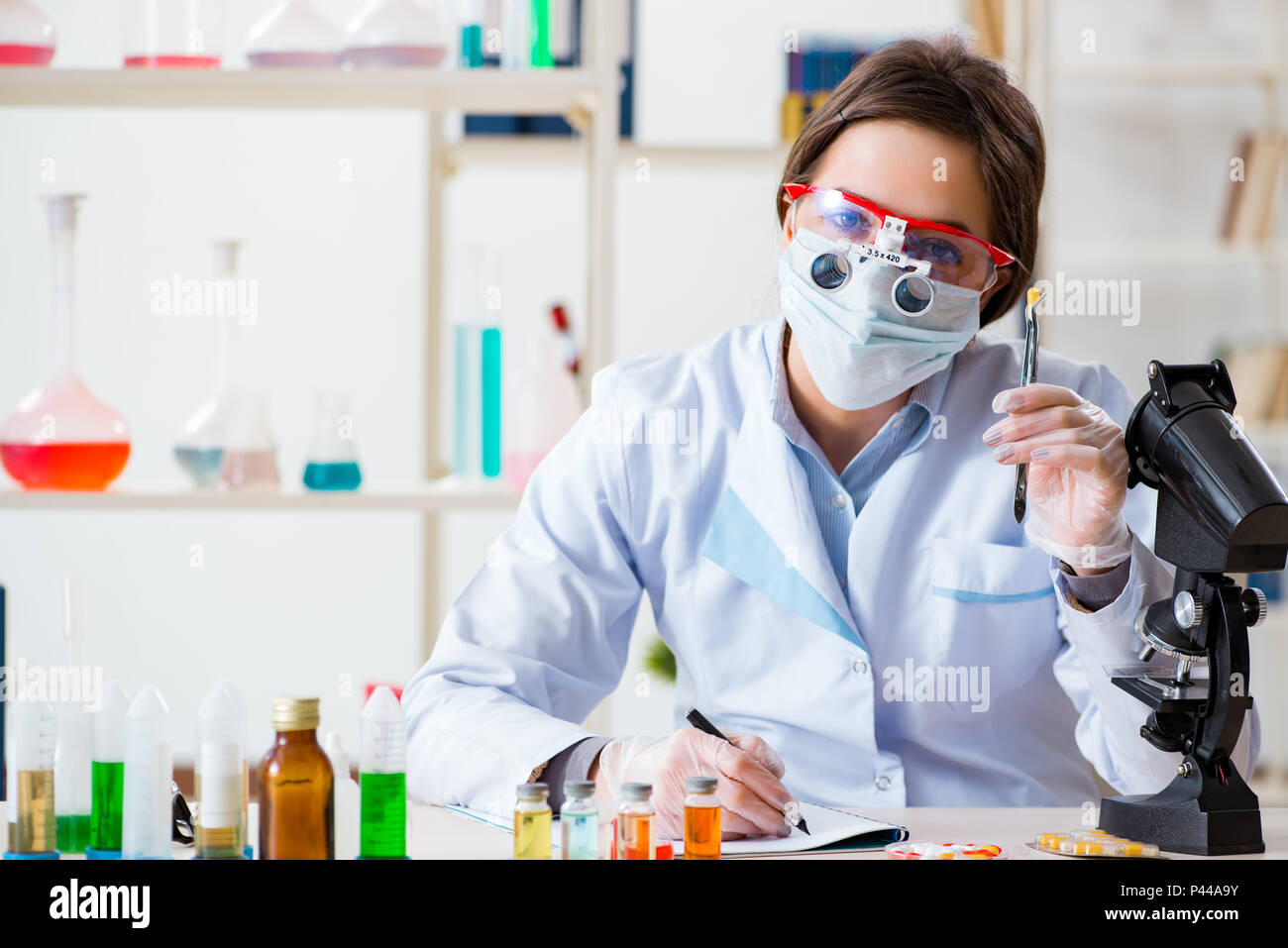 Lab assistant in drug synthesis concept Stock Photo - Alamy
