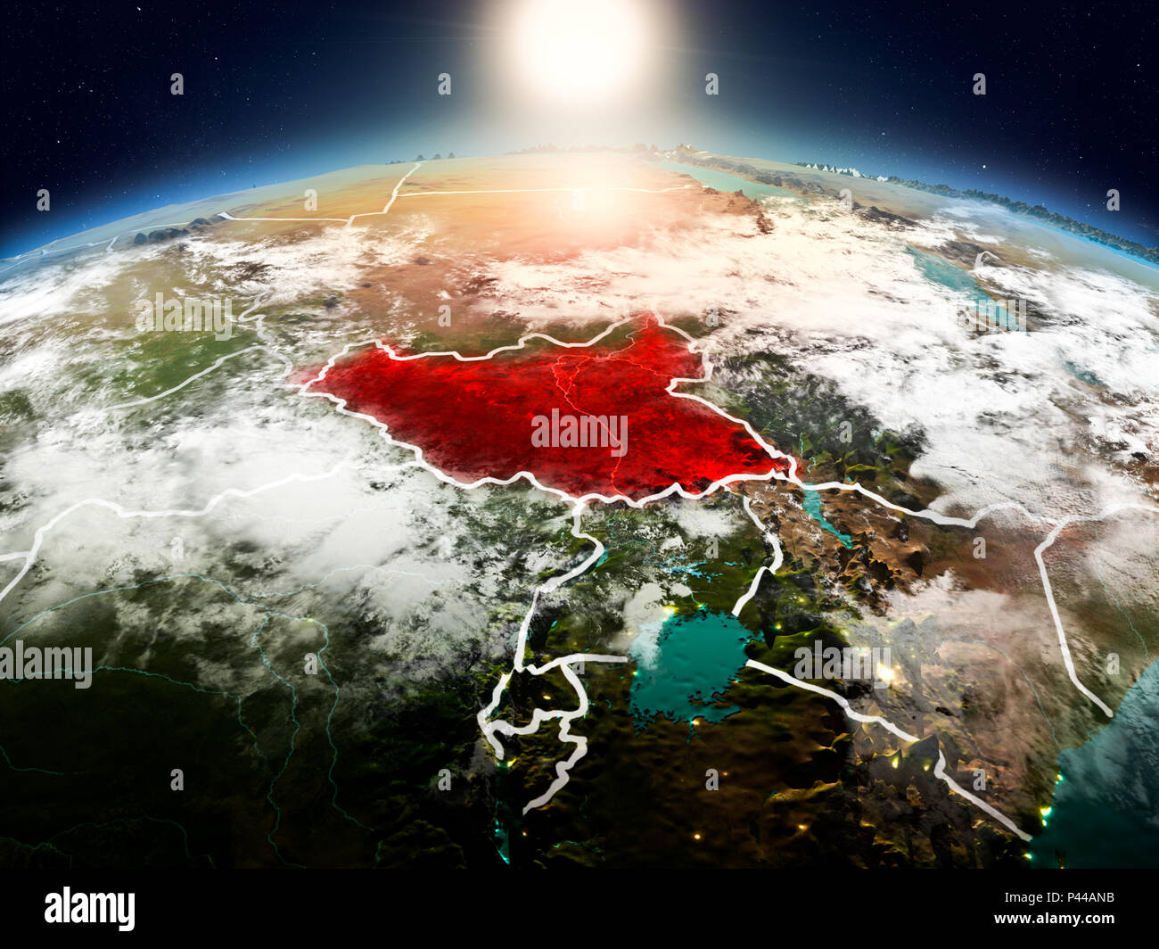 Sunrise above South Sudan highlighted in red on model of planet Earth in space with visible ...