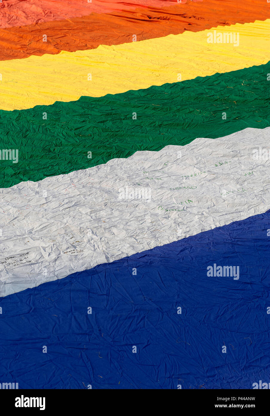 a large flag with the colors of peace during a demonstration for Peace ...