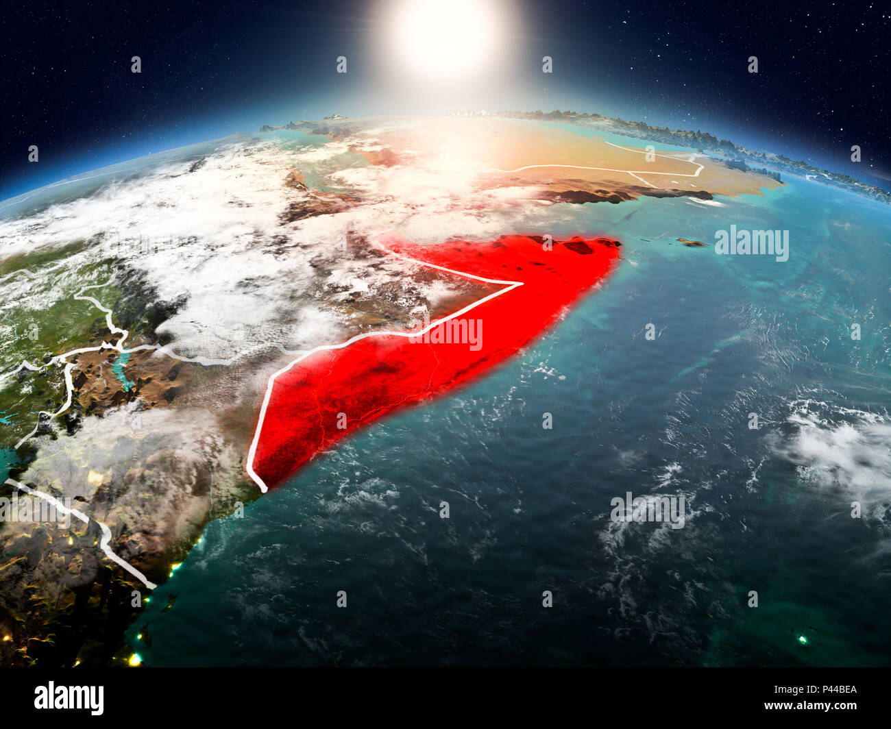 Sunrise above Somalia highlighted in red on model of planet Earth in space with visible country ...