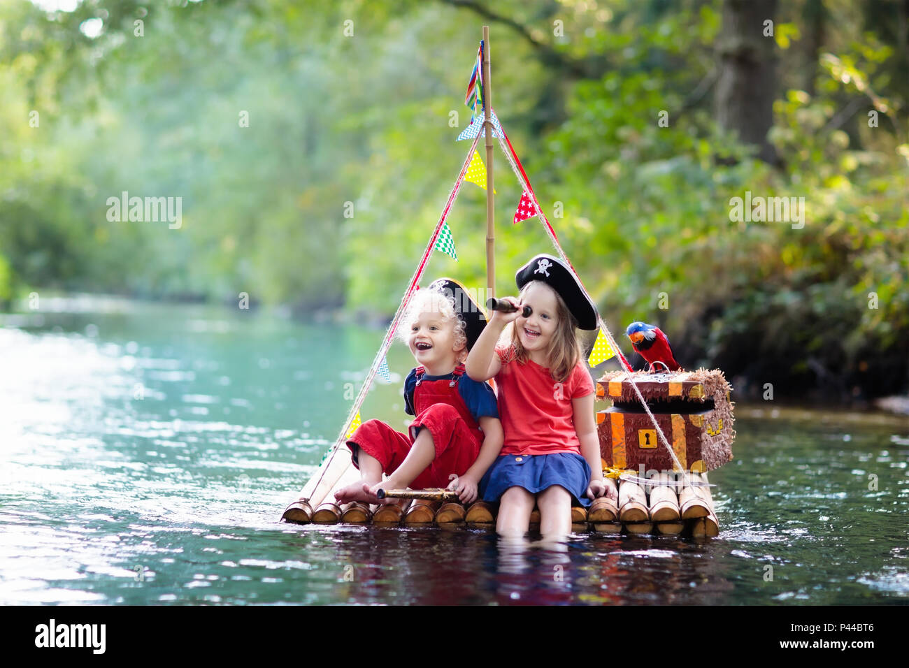 Kids dressed in pirate costumes and hats with treasure chest ...