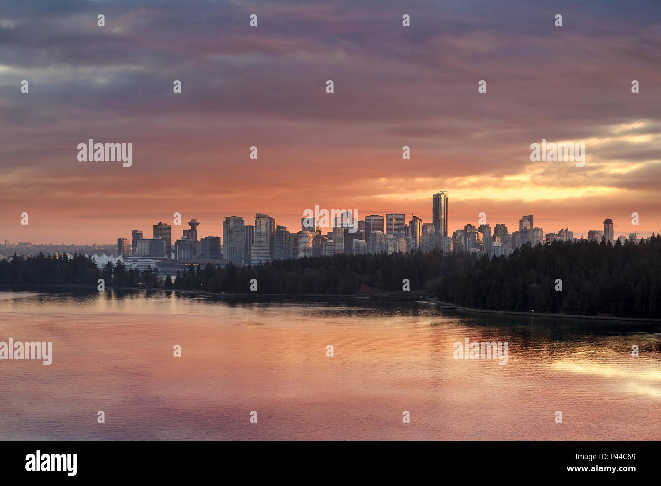 Colorful dramatic sunset color sky over Stanley Park and downtown city ...