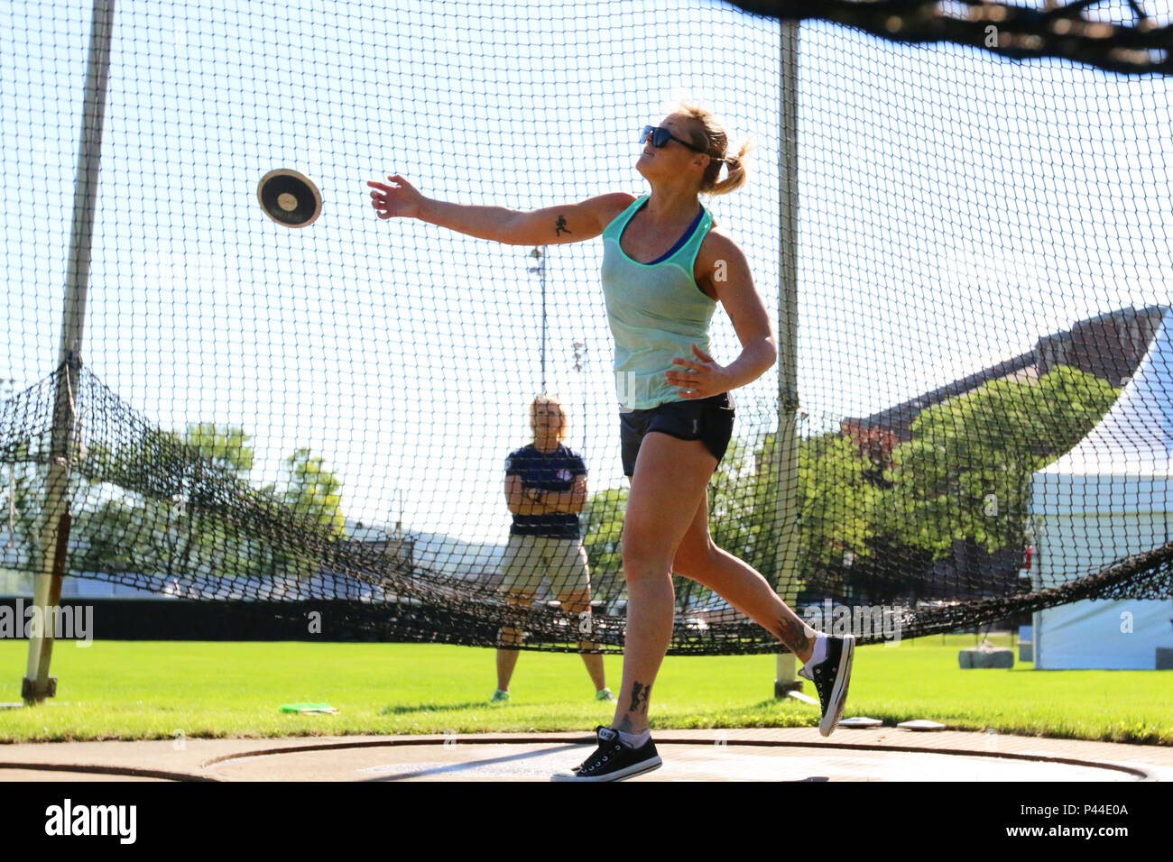 Navy Petty Officer 3rd Class Melissa Klotz hurls the discus at Shea ...