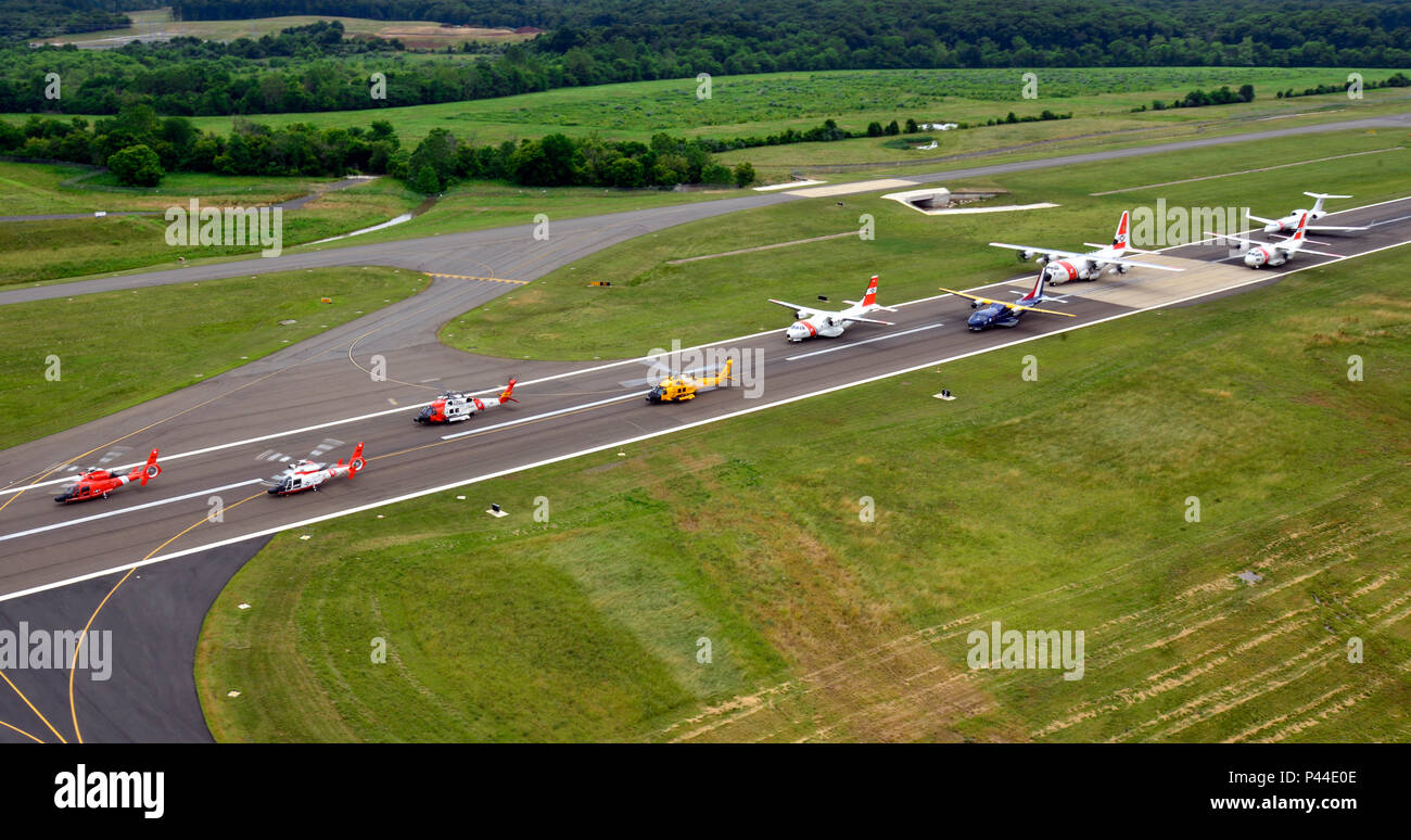 Nine U.S. Coast Guard aircraft sit on a runway at Manassas Regional ...