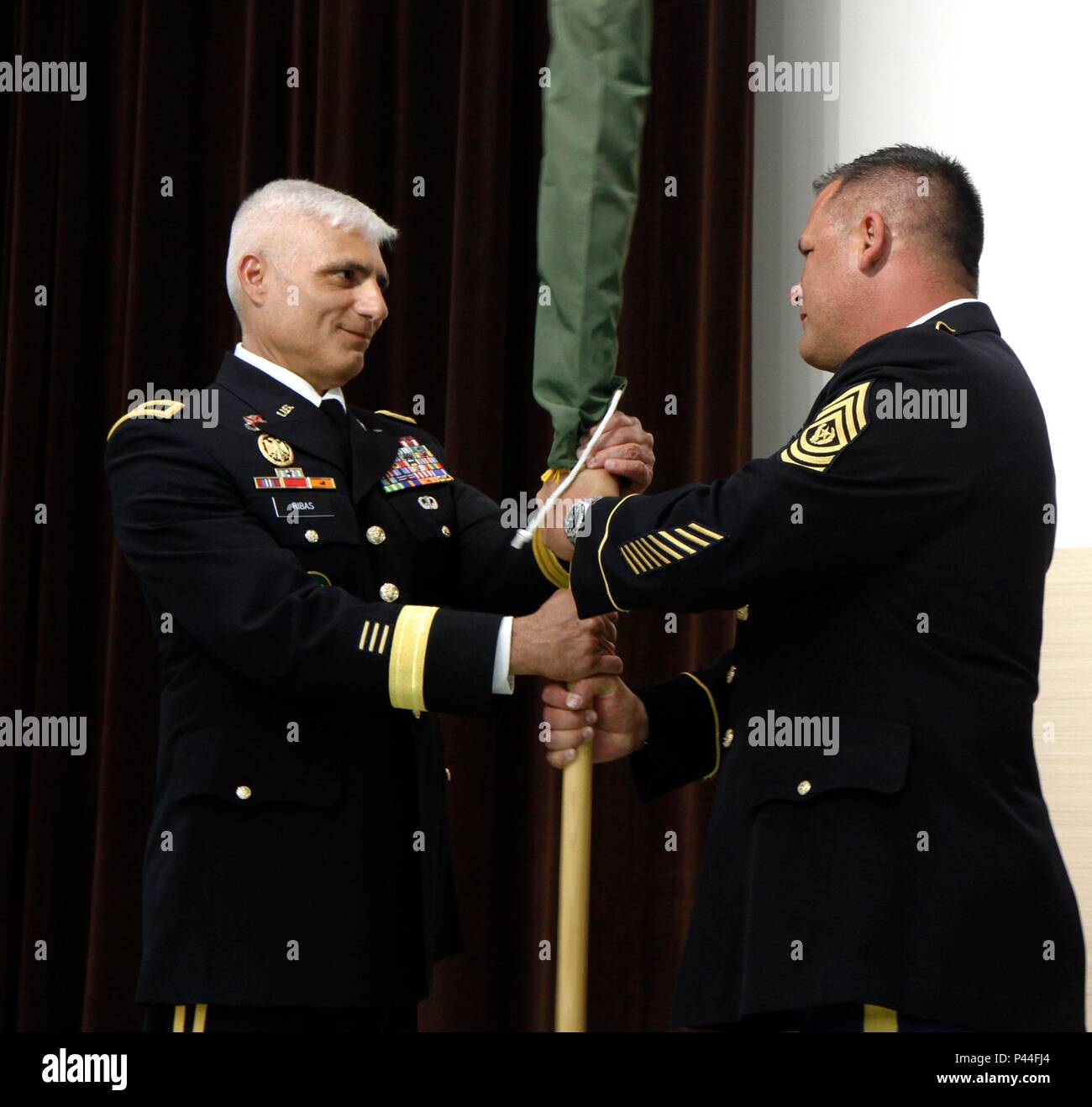 Brig. Gen. Ralph Ribas, embraces Chief Warrant Officer 5 Gerald Dedge ...