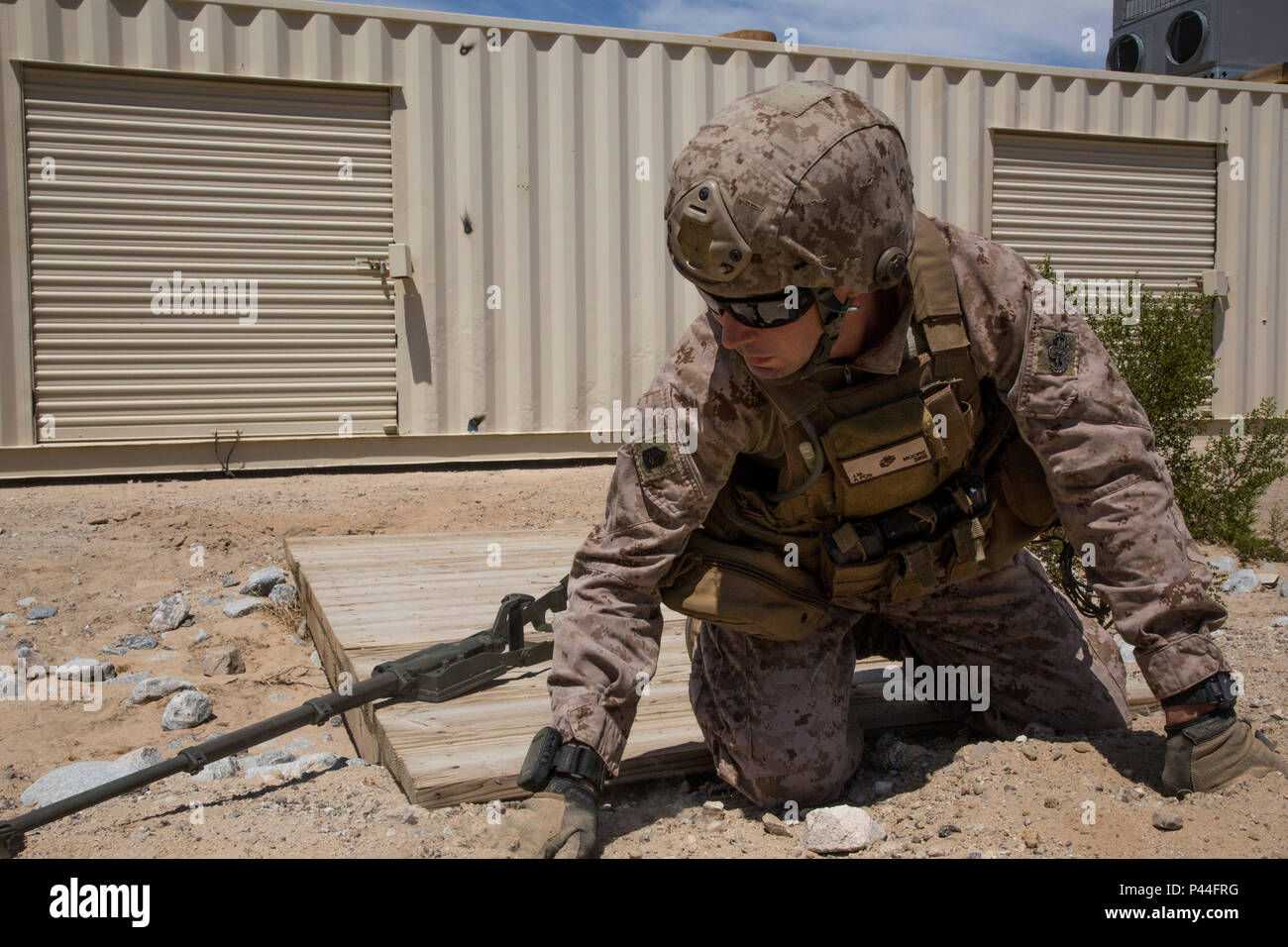 Gunnery Sgt. Joseph Moore searches for a simulated improvised explosive ...