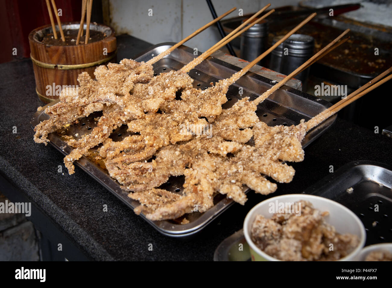 Fried delicious cuttlefish seafood on a stick ready to be eaten on the ...