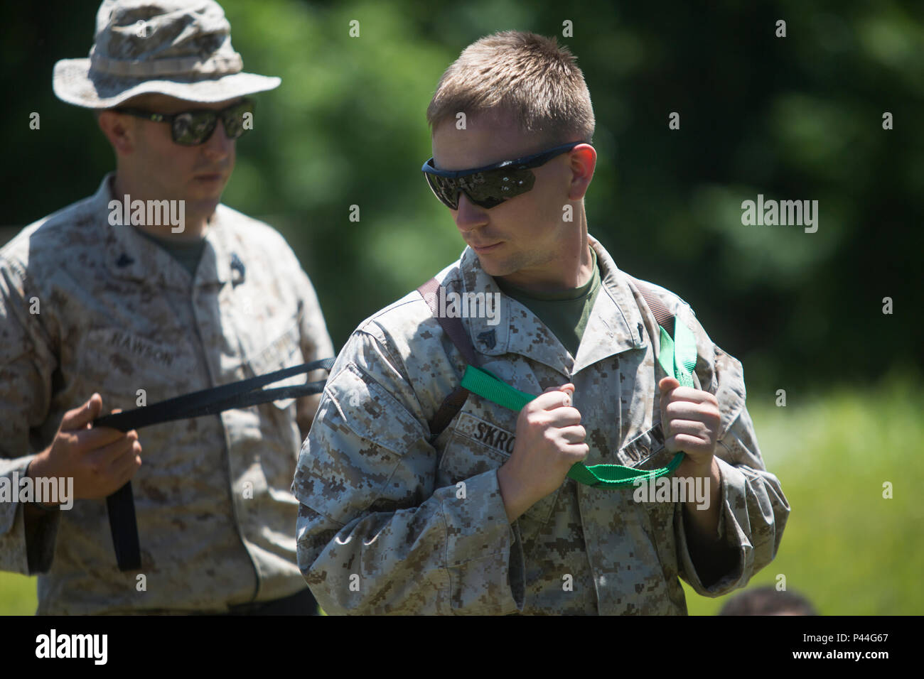 Petty Officer 3rd Class Benjamin Rawson (left), a Fleet Marine Force ...