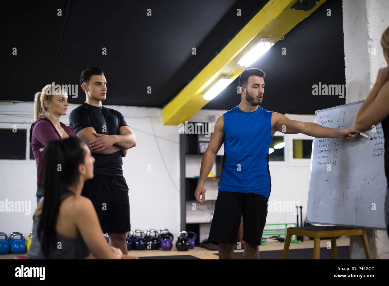 Training course.group of young athletes getting instructions from ...