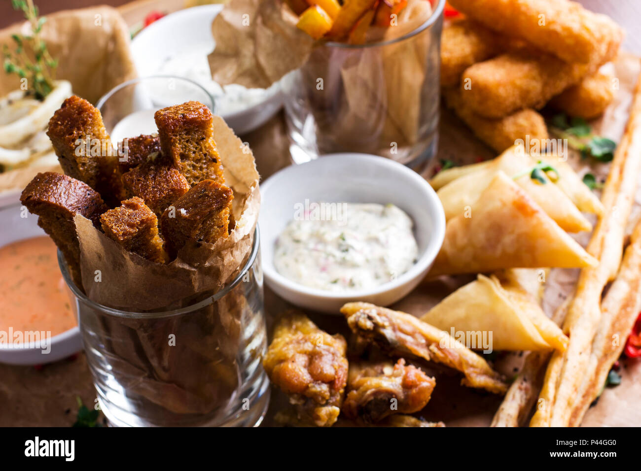 Spicy crackers with different snacks for beer Stock Photo - Alamy