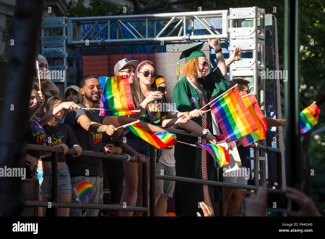 NEW YORK CITY - JUNE 25, 2017: Participants wave rainbow flags on a ...