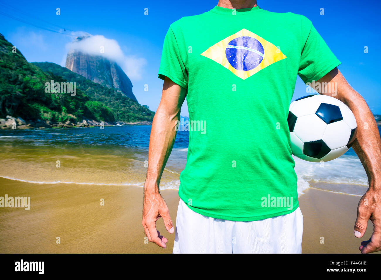 Soccer player holding football wearing shirt in Brazil flag colors at ...