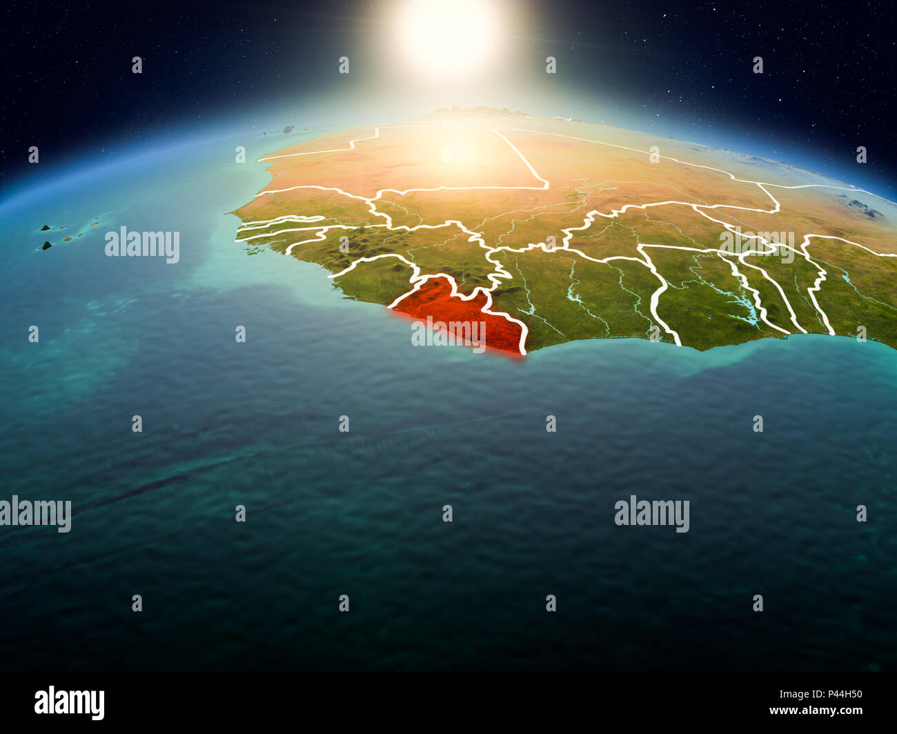 Sunrise above Liberia highlighted in red on model of planet Earth in space with visible country ...