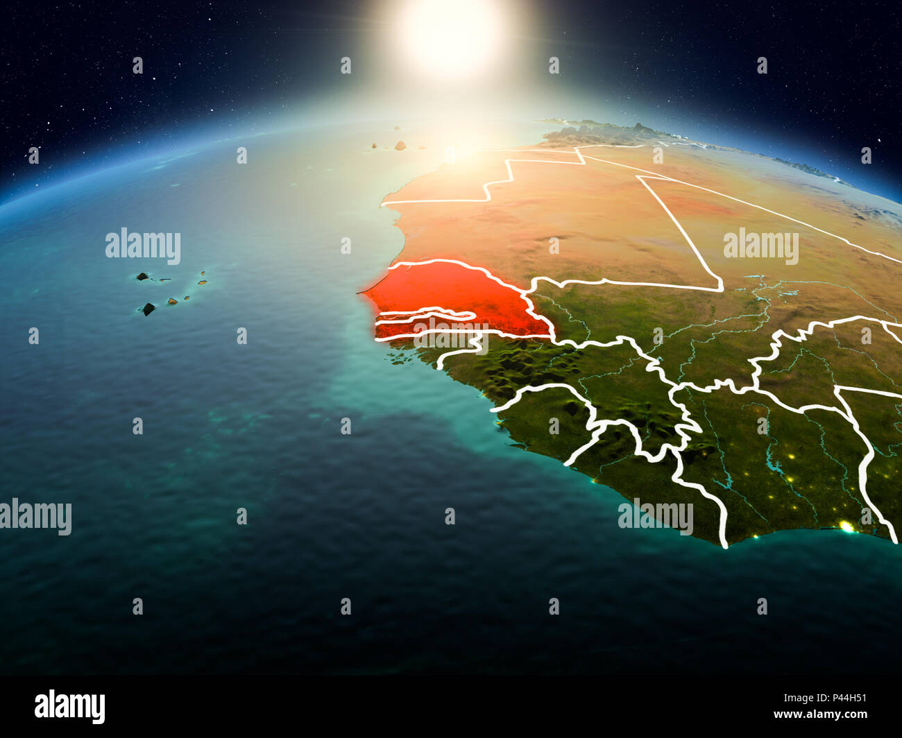Sunrise above Senegal highlighted in red on model of planet Earth in space with visible country ...
