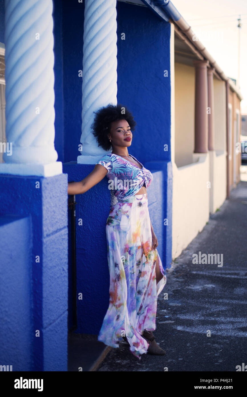 An African model poses against a newly painted and updated historical ...
