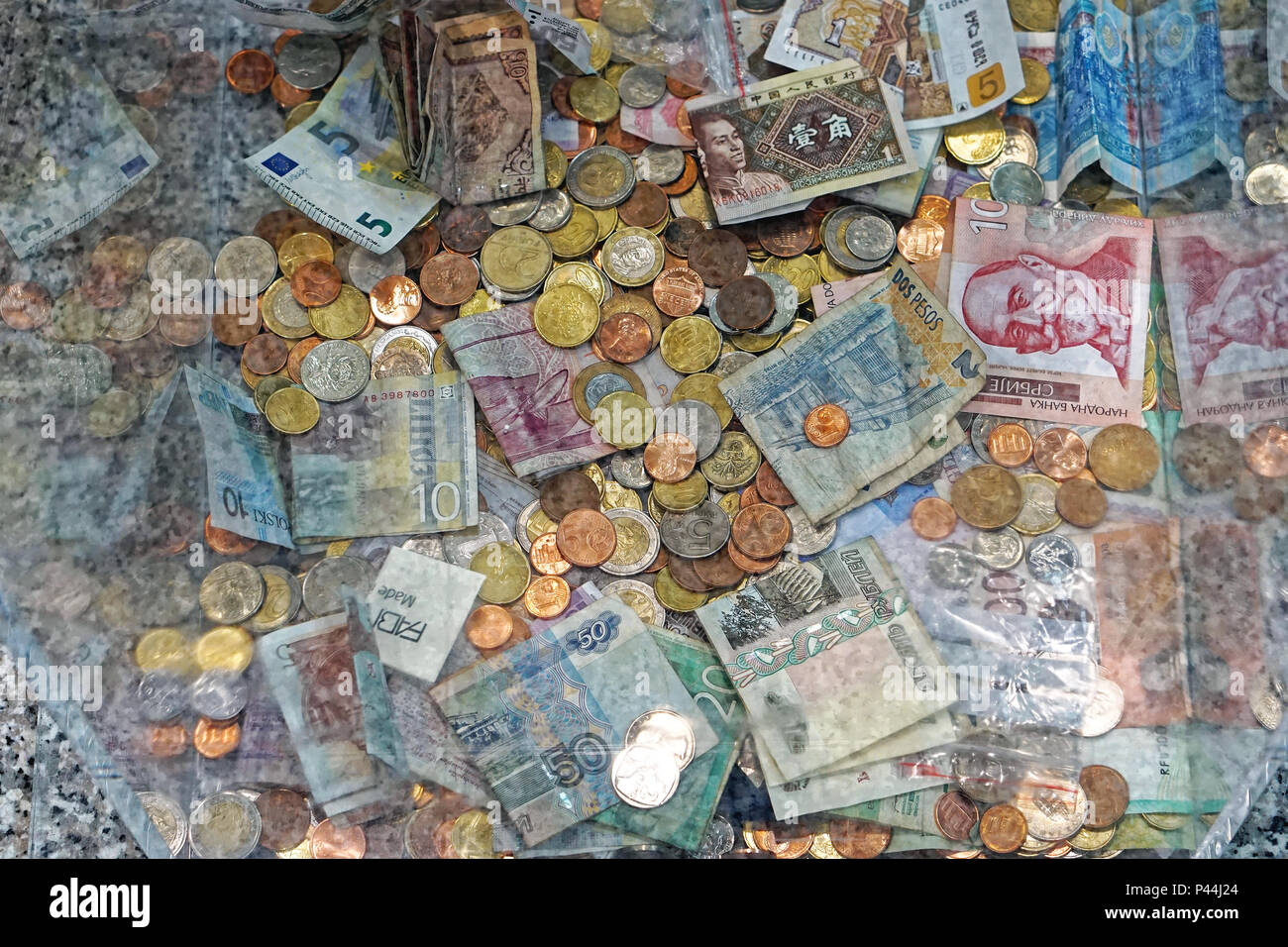 Mix coins and banknotes currency in clear donation money box Stock ...