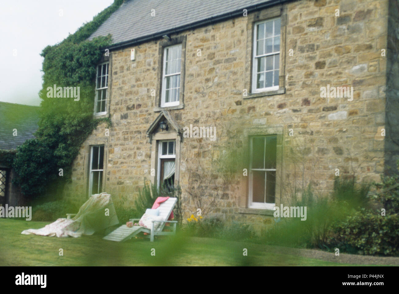 Exterior of traditional stone cottage in England Stock Photo - Alamy