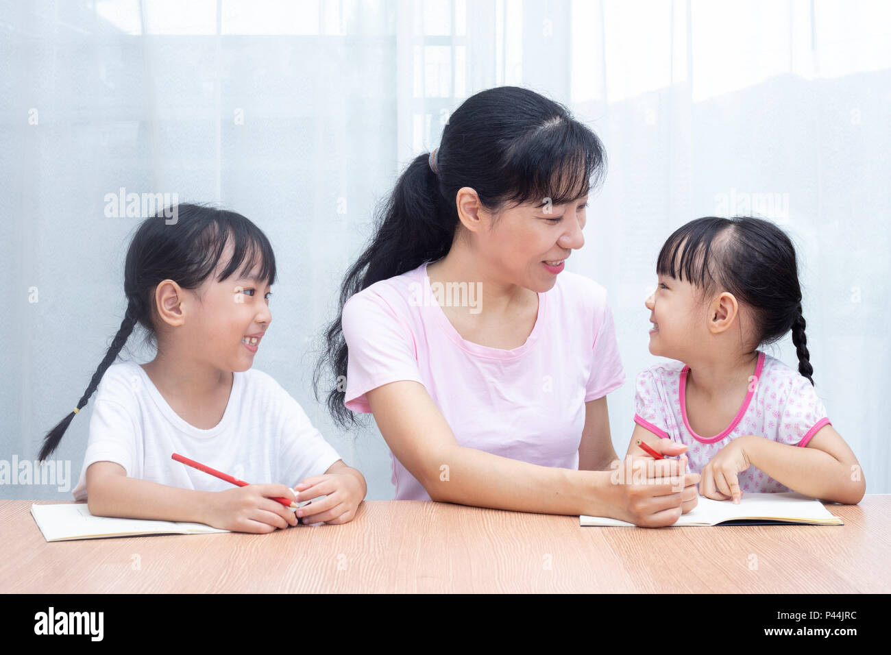 Asian family teaching their kids hi-res stock photography and images ...