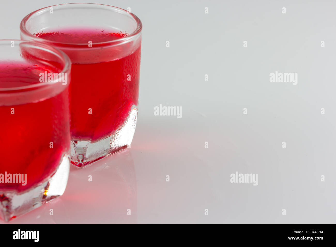 a glass of red water isolate in white background Stock Photo - Alamy