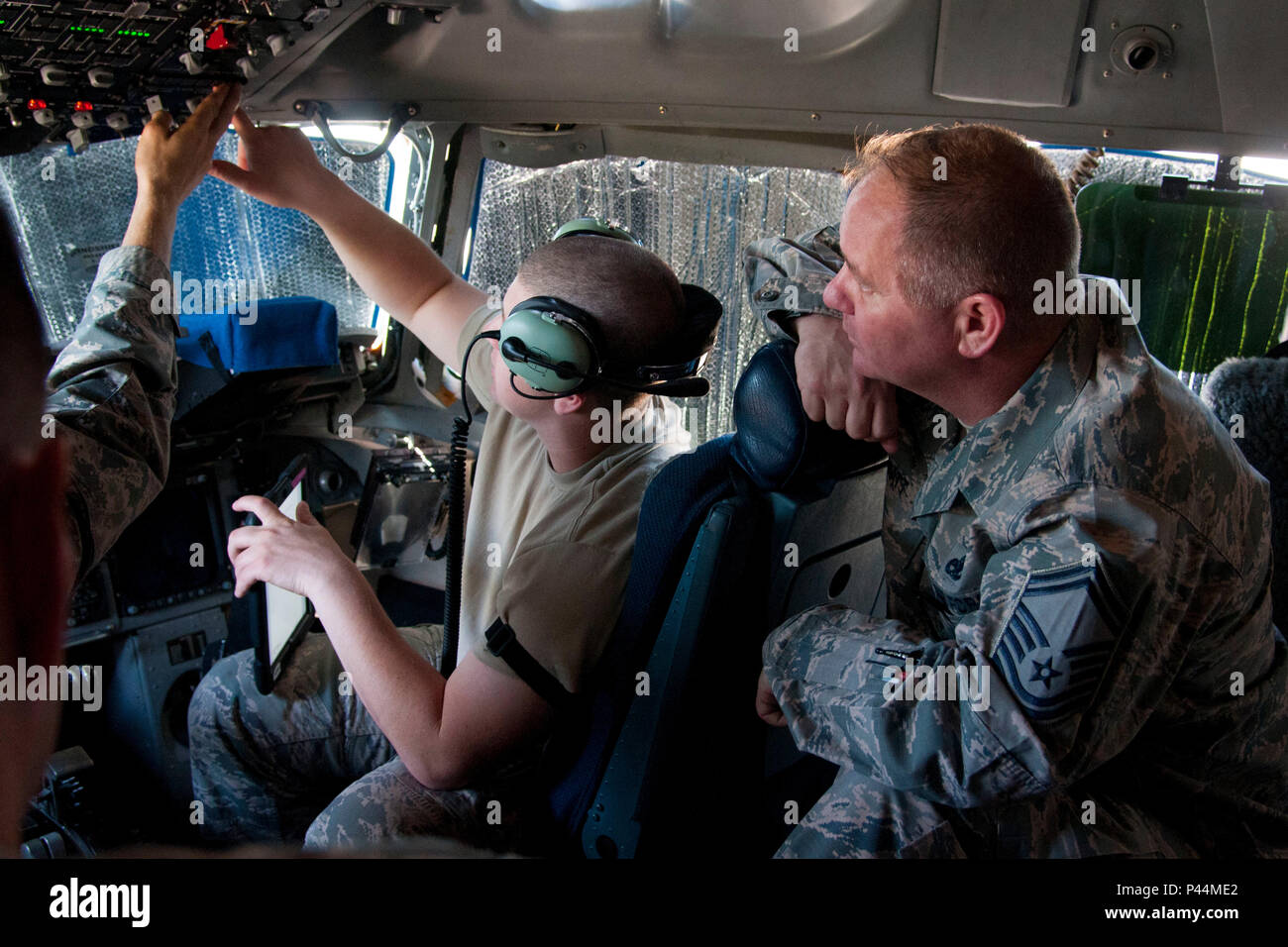 Staff Sgt. Derek Meacham (left), a member of the communication and ...