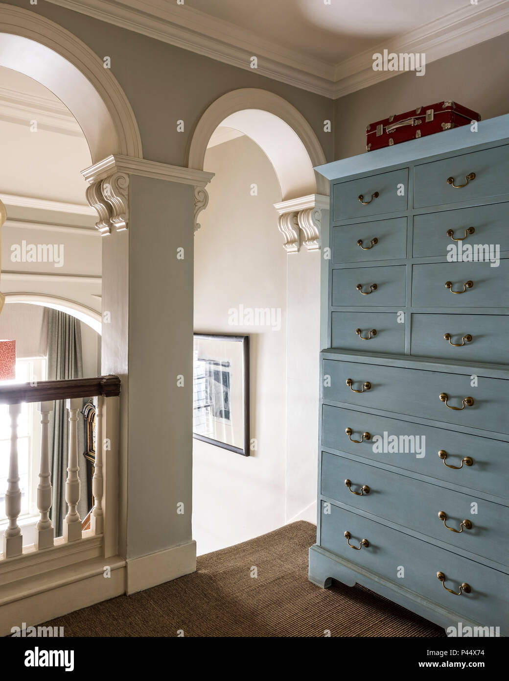 Large blue storage drawers on landing in Victorian home Stock Photo - Alamy