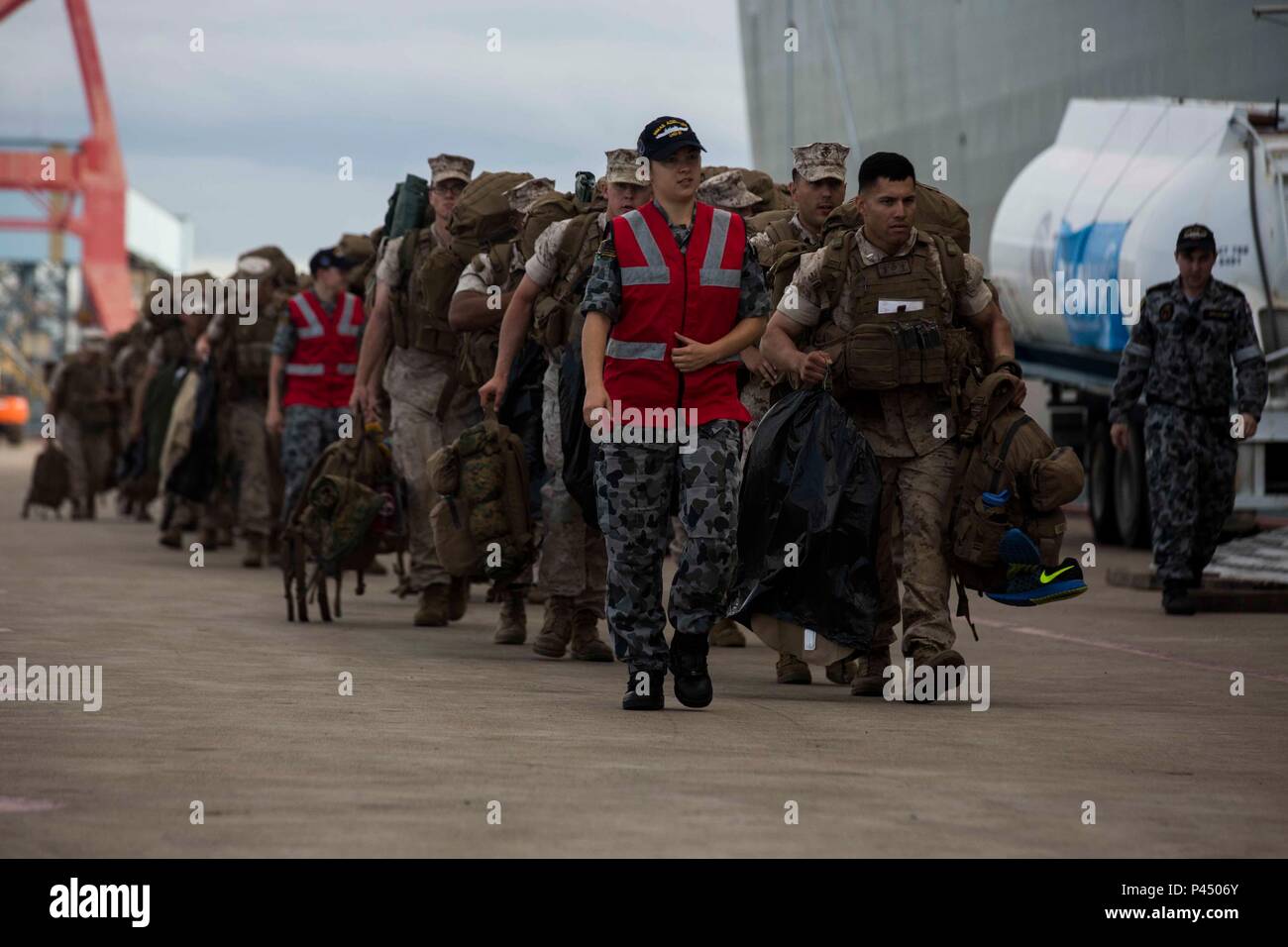 U.S. Marines prepare to go aboard the HMAS Adelaide at Port of Brisbane ...