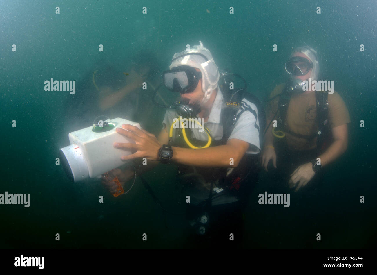 An Explosive Ordnance Disposal Technician (right), assigned to ...