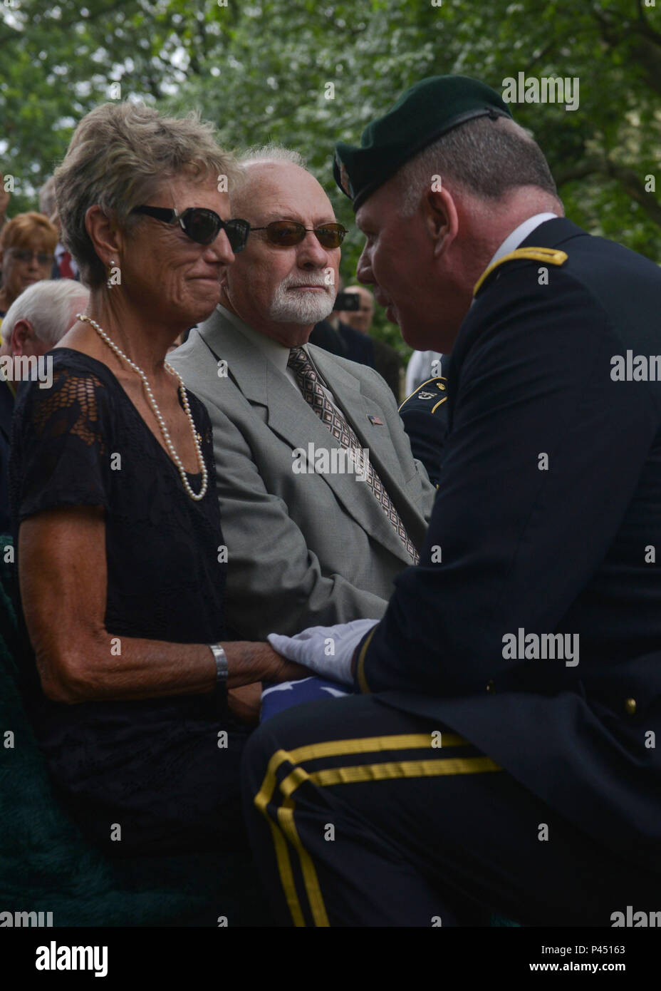 Judi Boyer-Bouchard receives the flag from her brother, returned Sgt ...