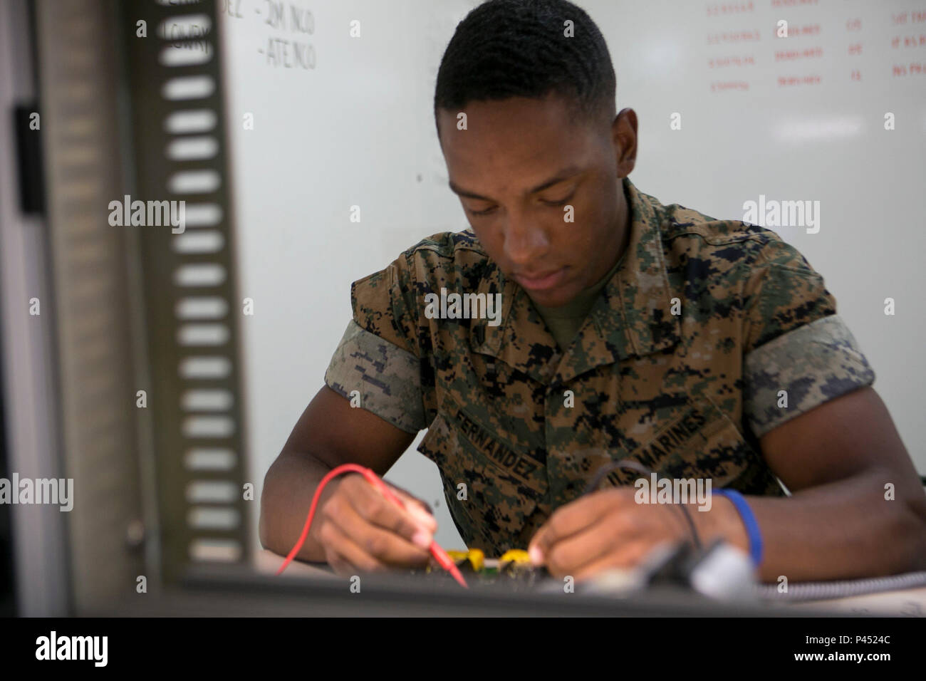 Cpl. Jamie Fernandez diagnoses a faulty circuit card on Camp Courtney ...