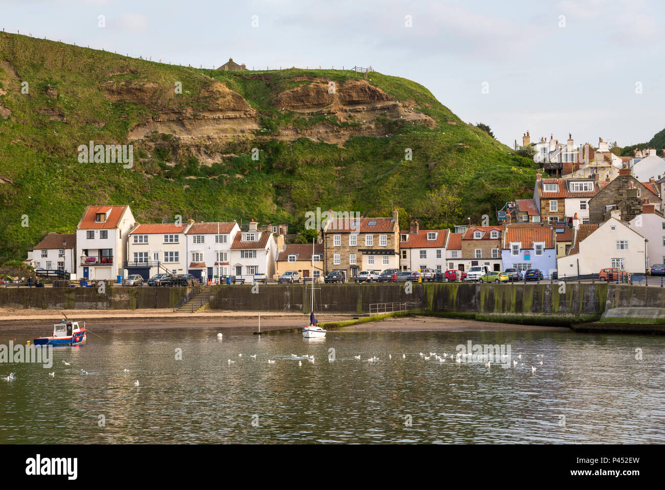 High tide at Staithes harbour on the coast of North Yorkshire, England ...