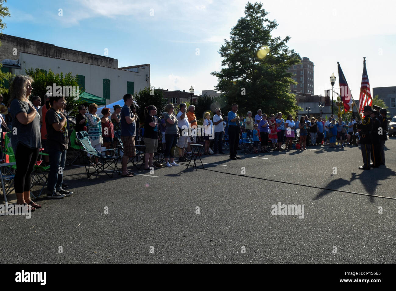 Members of the base and local community stand during the playing of the ...