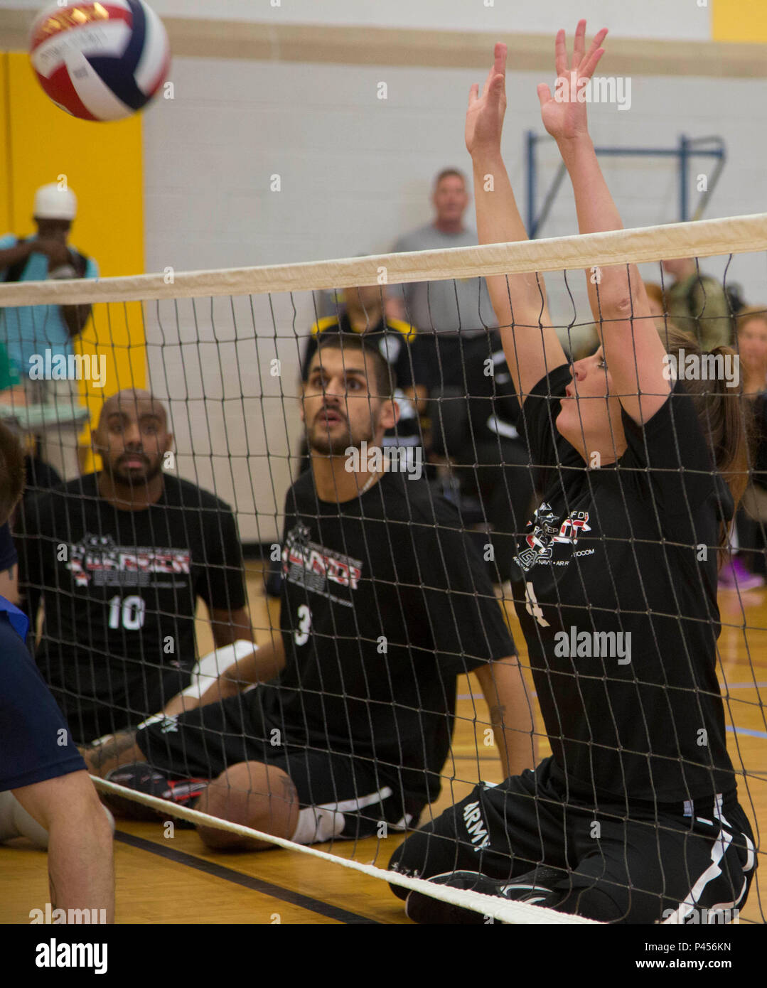 Team Army athletes participate in a sitting volleyball match against ...